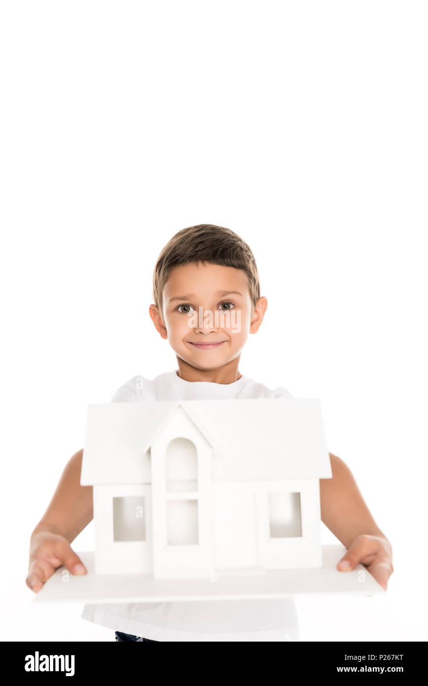 portrait of smiling little boy holding house model isolated on white ...