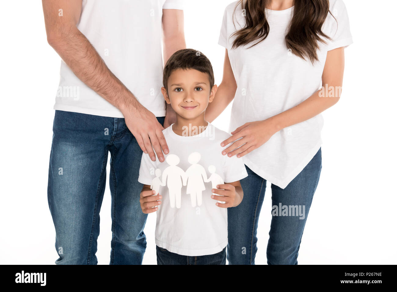 partial view of smiling little boy with family model in hands and ...
