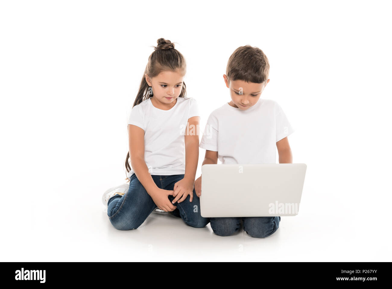 little kids using laptop together isolated on white Stock Photo - Alamy
