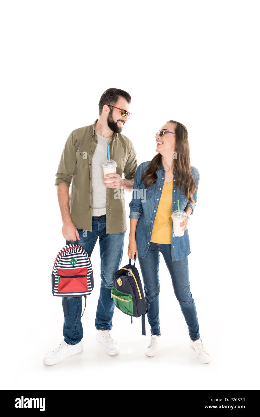 happy boyfriend and girlfriend in sunglasses with backpacks and ...