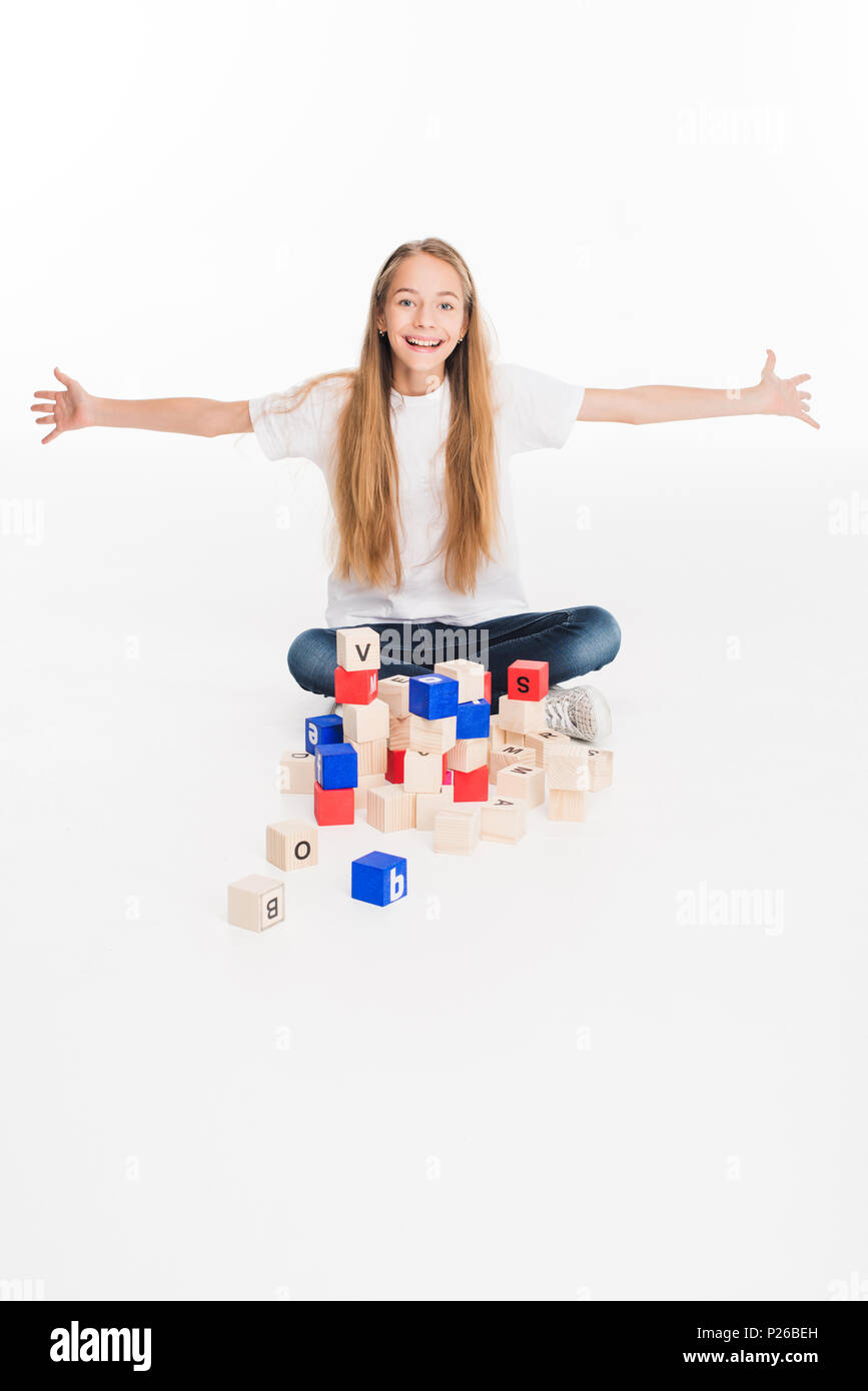 adorable smiling female child playing with alphabet blocks, isolated on ...