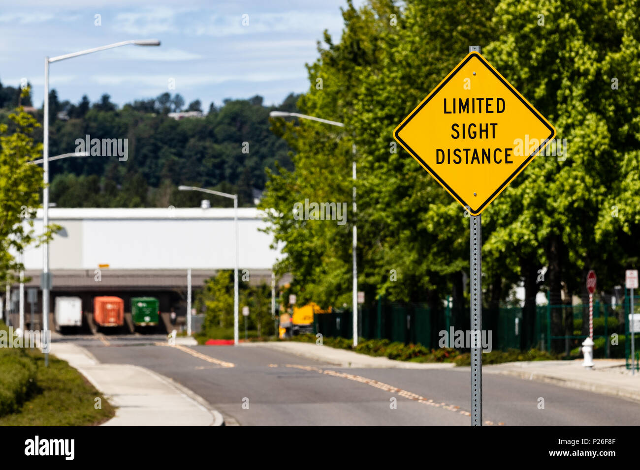 Limited Sight Distance sign on a road with trees and trailers Stock ...