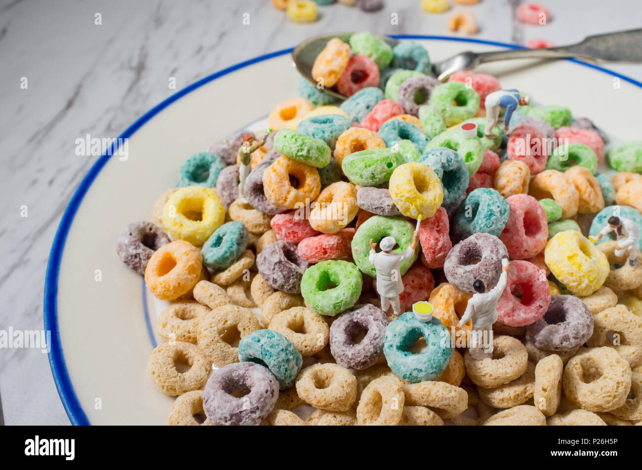 Tiny painting crew paints the oat loop cereal rainbow of colors Stock ...