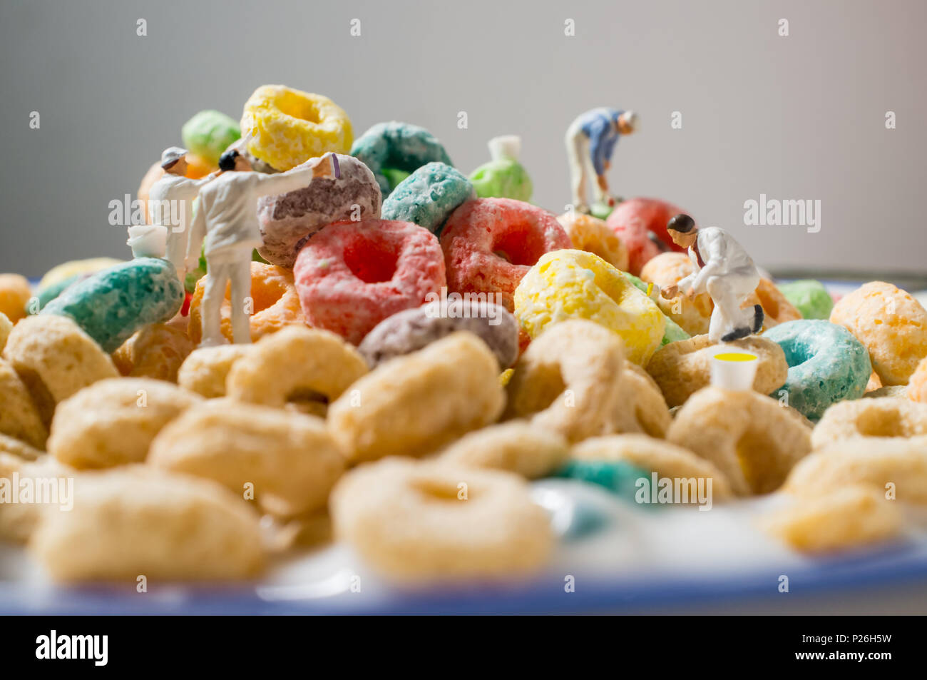 Tiny painting crew paints the oat loop cereal rainbow of colors Stock ...