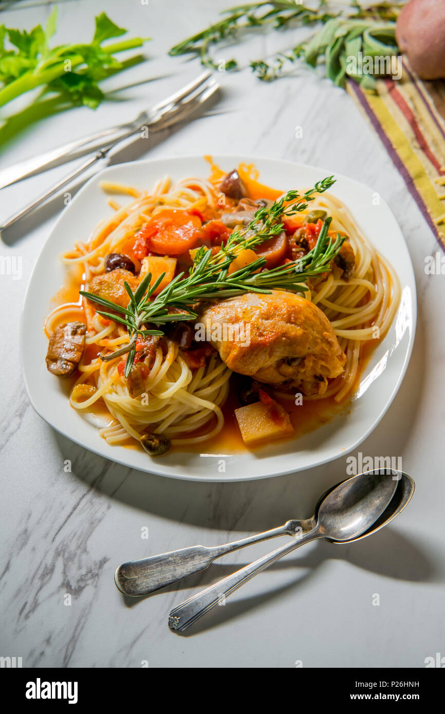 Italian chicken Cacciatore hunter's stew with spaghetti noodles and ...