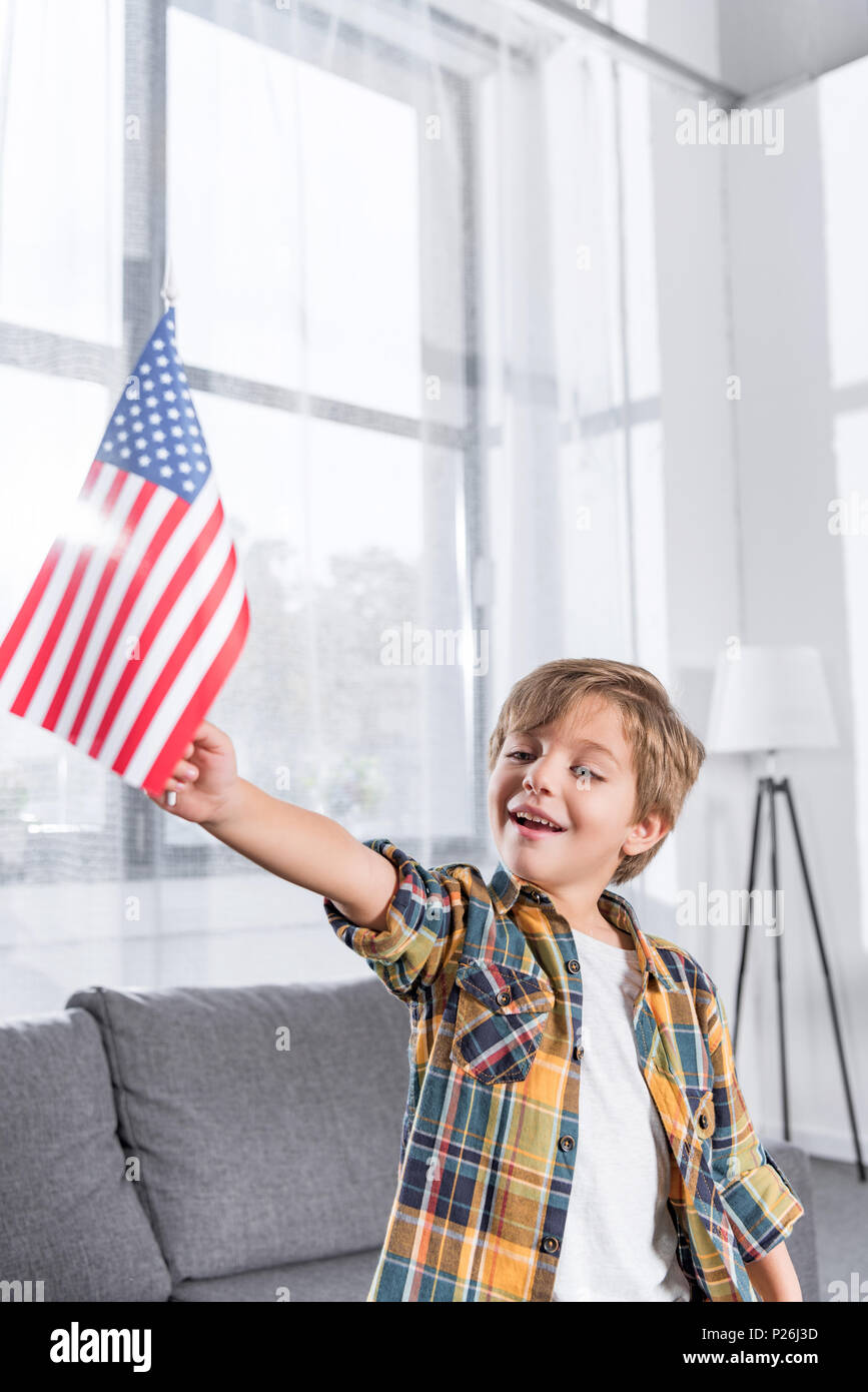 happy little boy holding usa flag at home Stock Photo - Alamy
