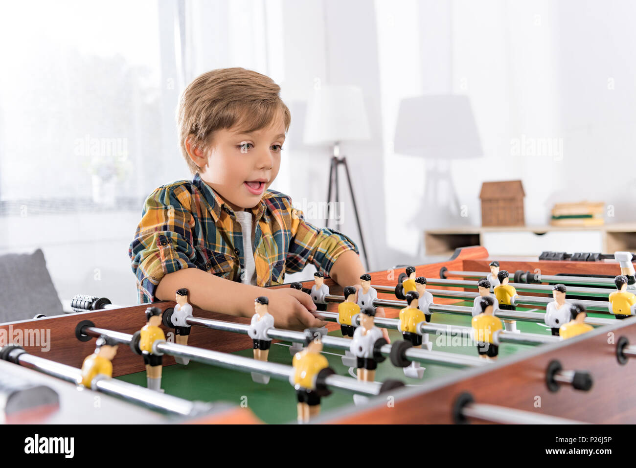 happy little boy playing table football Stock Photo - Alamy