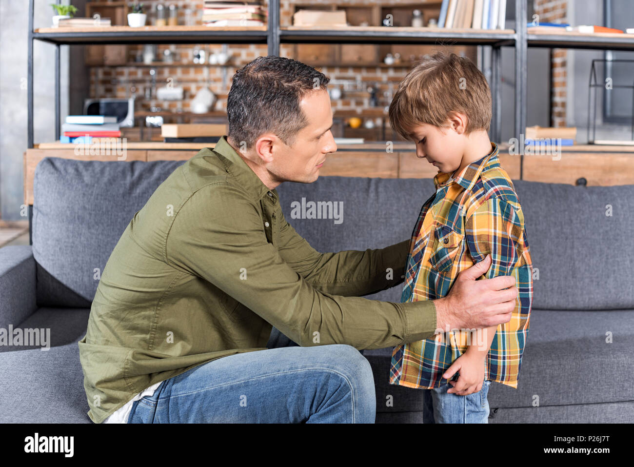 side view of father talking to depressed son at home Stock Photo - Alamy