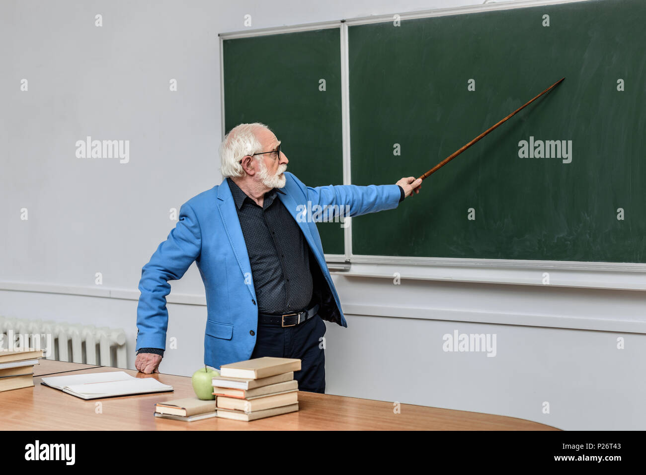 grey hair professor pointing on something at blackboard Stock Photo - Alamy