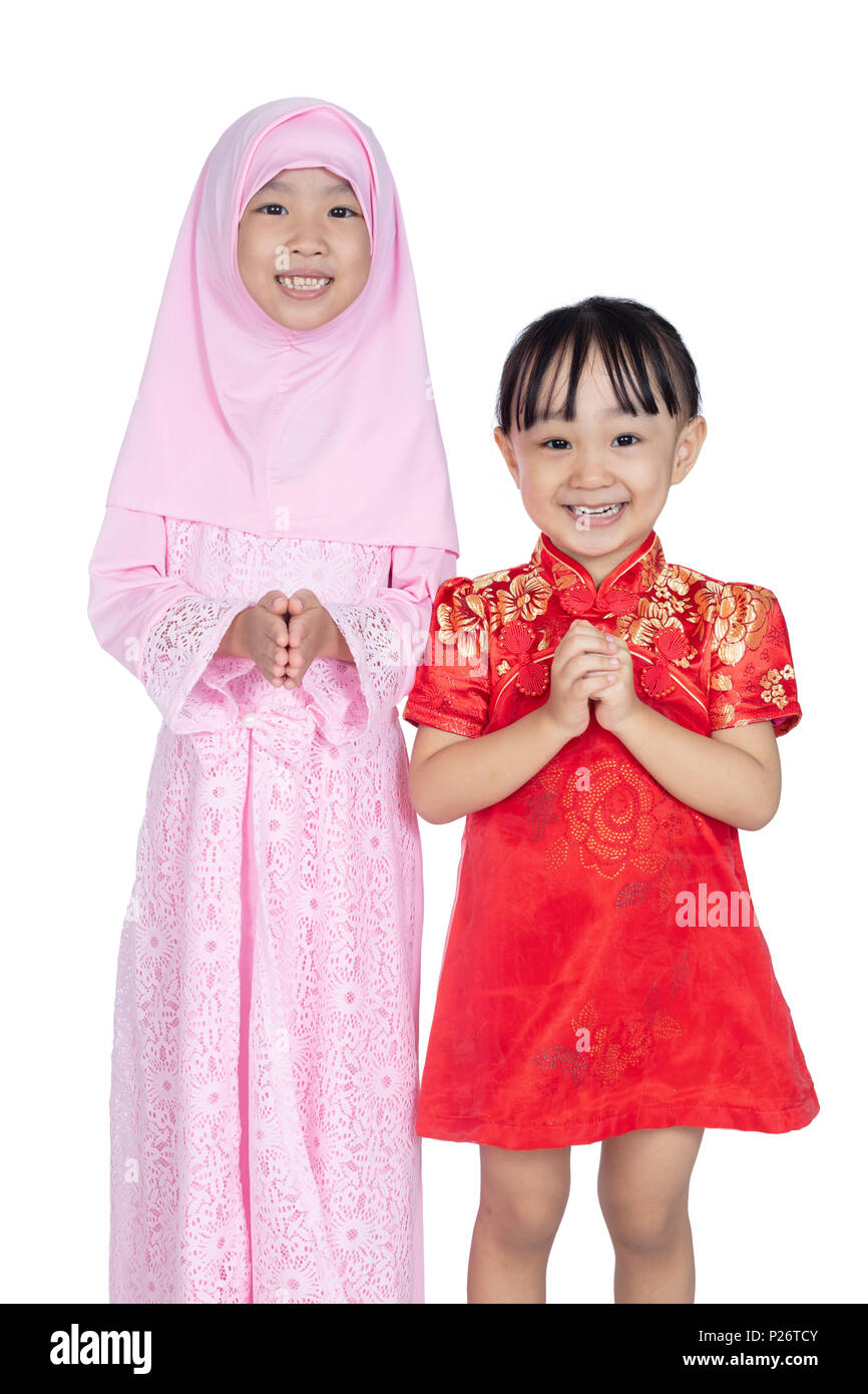 Asian Chinese little sisters wearing cheongsam and traditional Malay ...