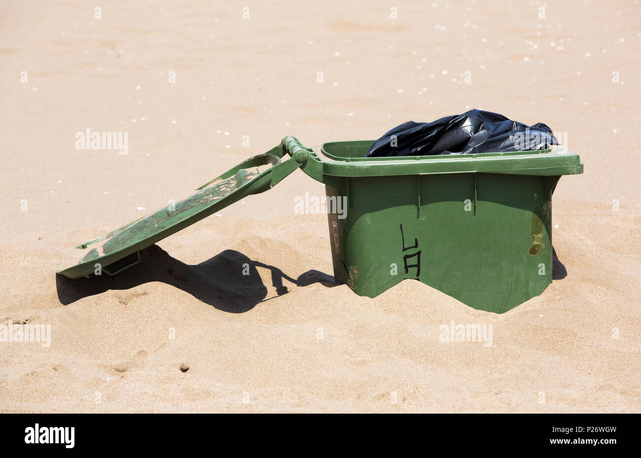 A litter bin buried in sand on the beach at Aiguamolls de l'empordà in ...