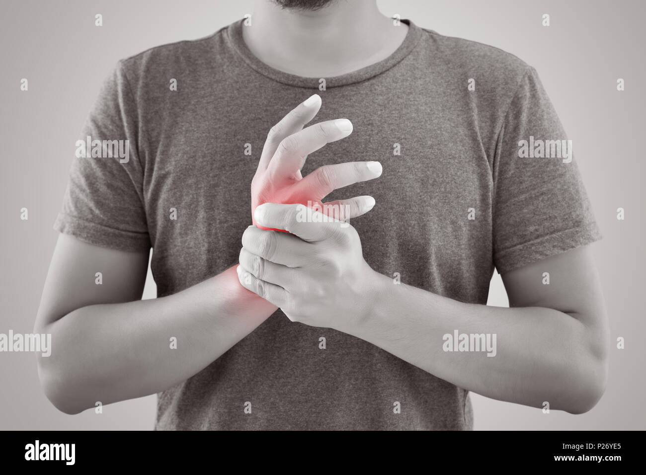 Asian man with pain in wrist against gray background. People suffering ...