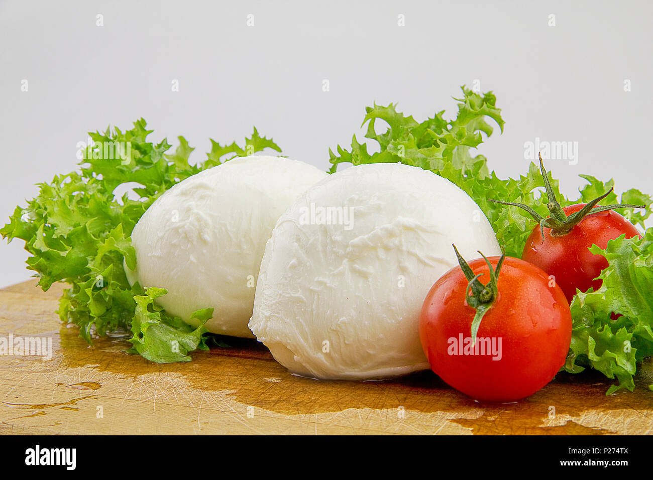 italian mozzarella on cutting board with white background Stock Photo ...