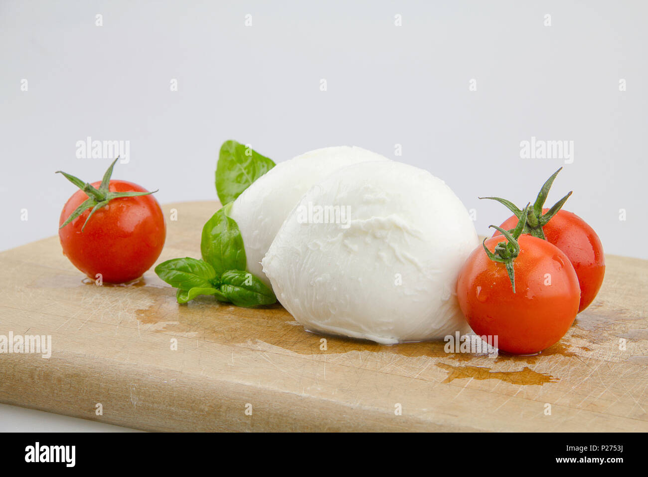 italian mozzarella on cutting board with white background Stock Photo ...