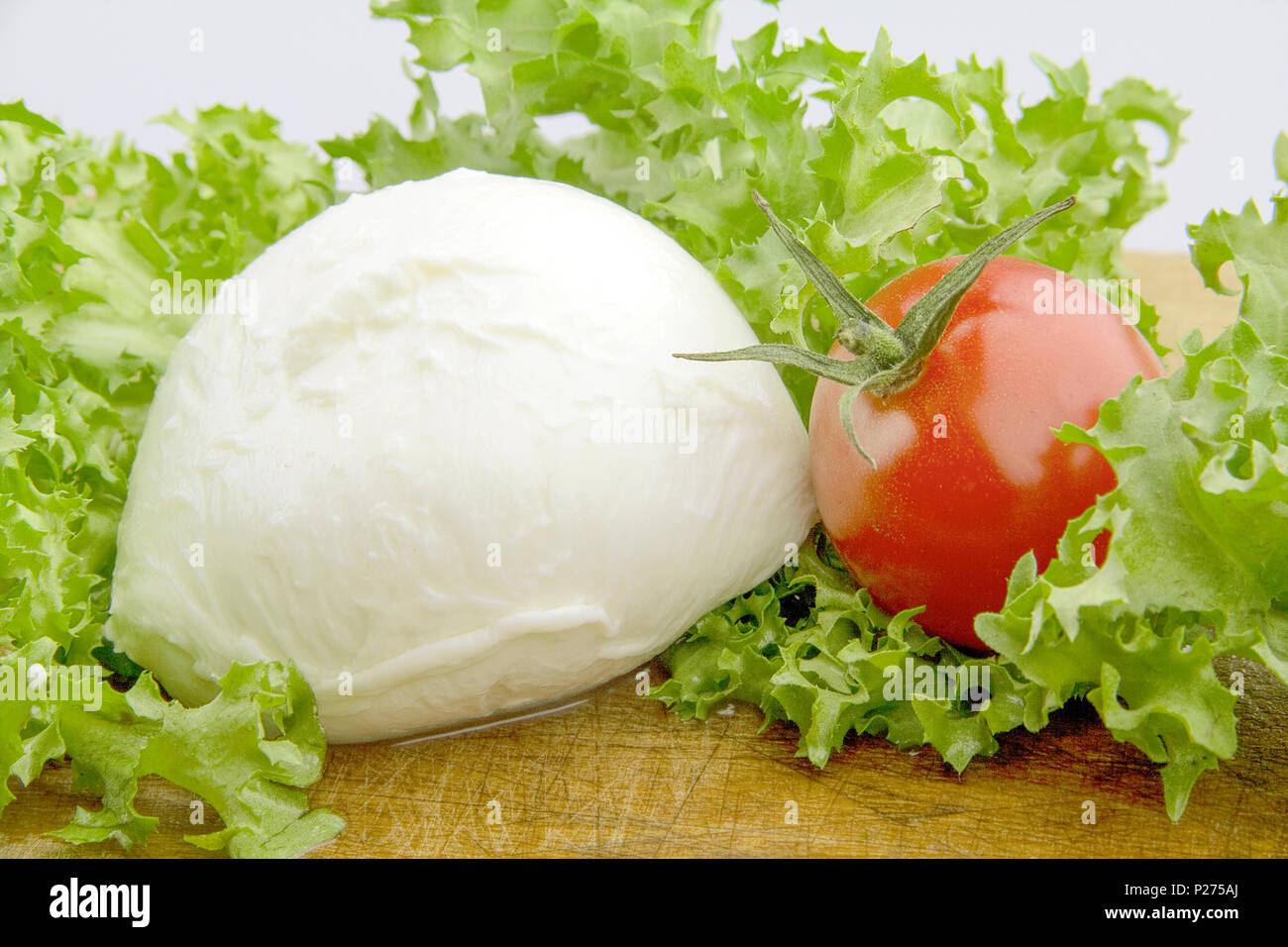 italian mozzarella on cutting board with white background Stock Photo ...