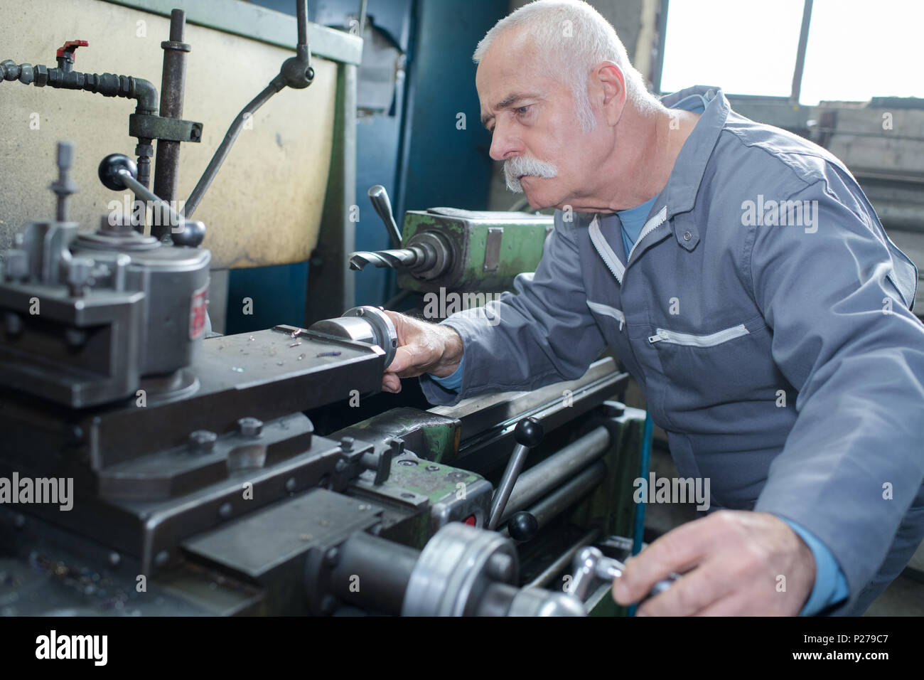 senior male carpenter cutting wood at construction site Stock Photo - Alamy