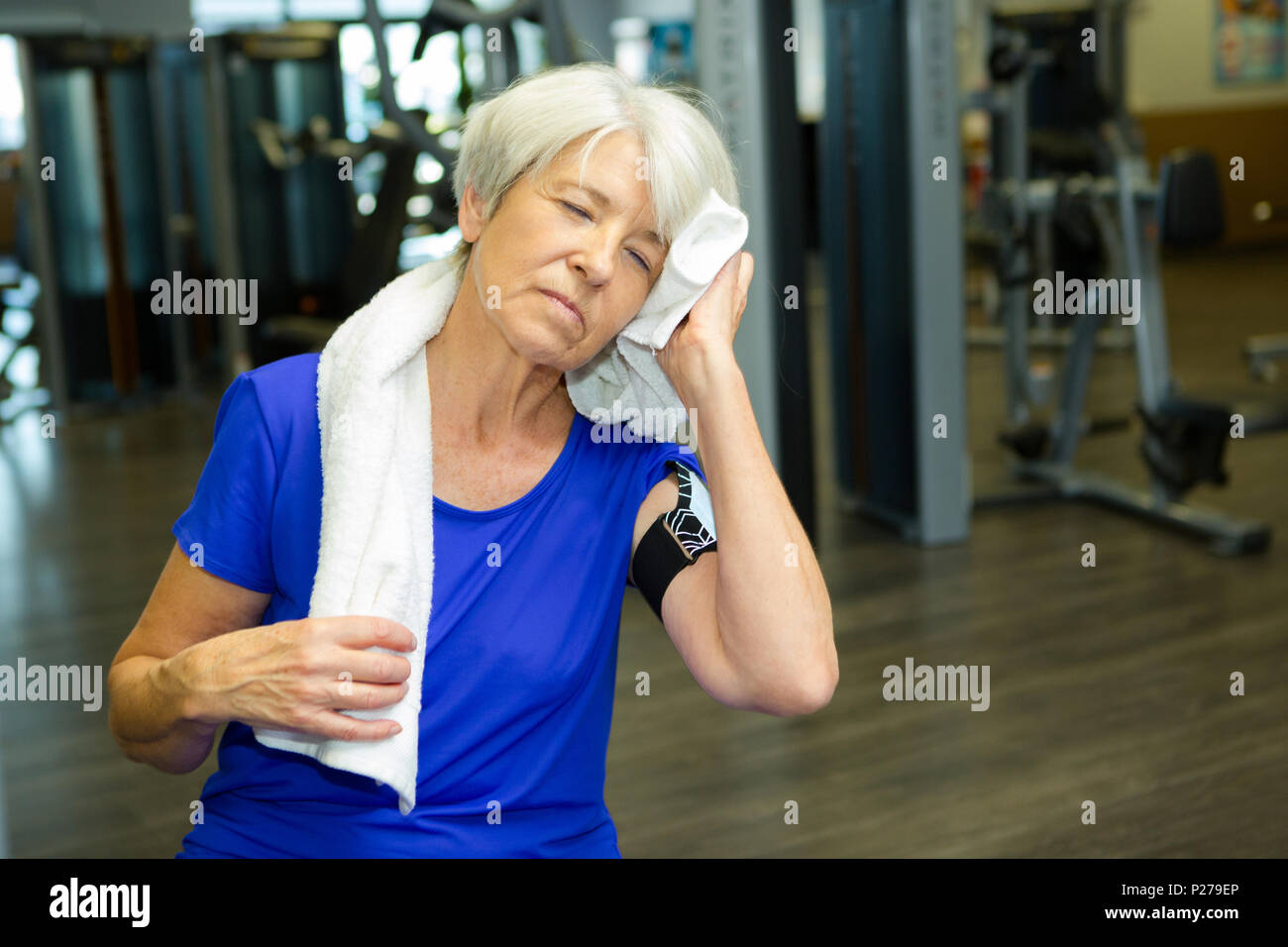 senior woman wiping off sweat off her forehead Stock Photo - Alamy