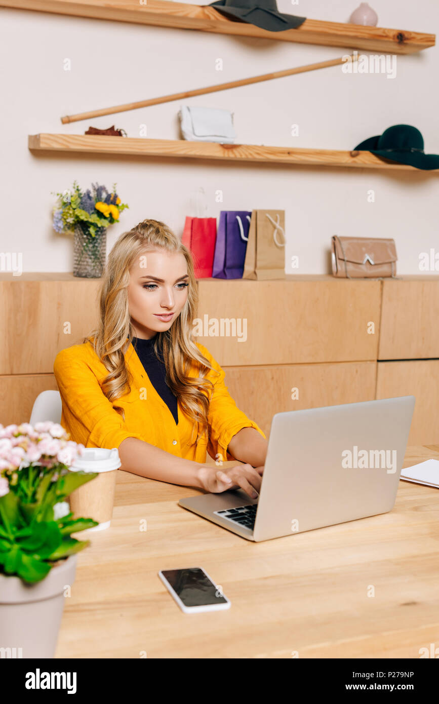 clothing store manager working with laptop at workplace Stock Photo - Alamy