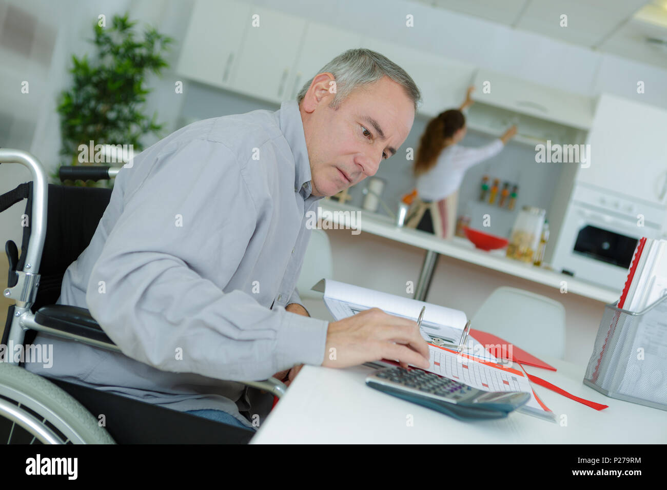 handicapped man on wheelchair working from home Stock Photo - Alamy