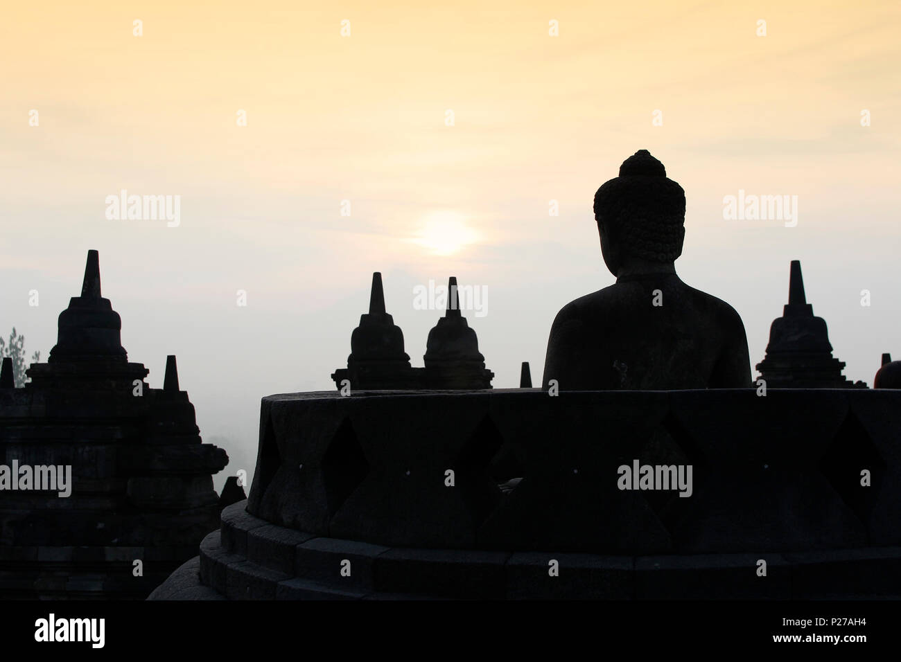 Silhouette Borobudur Temple with the Buddha statue at dawn, Yogyakarta ...