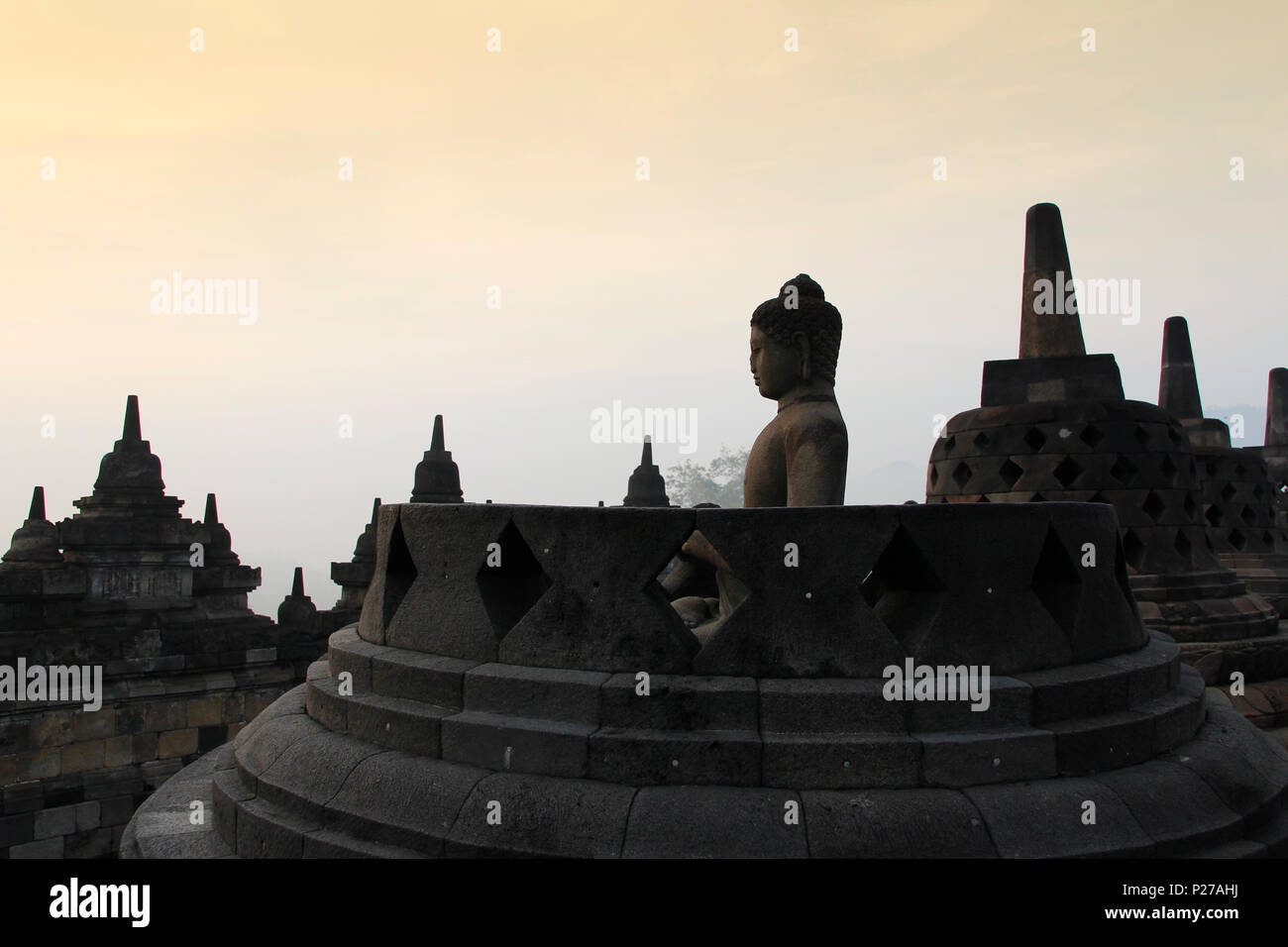 Silhouette Borobudur Temple with the Buddha statue at dawn, Yogyakarta ...