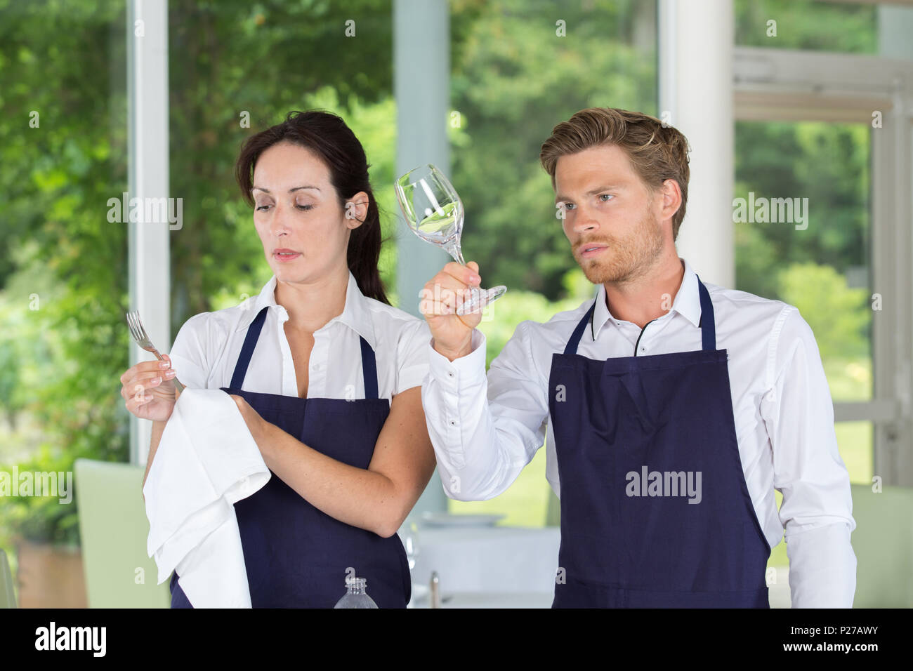 catering restaurant waitress and waiter setting table Stock Photo - Alamy