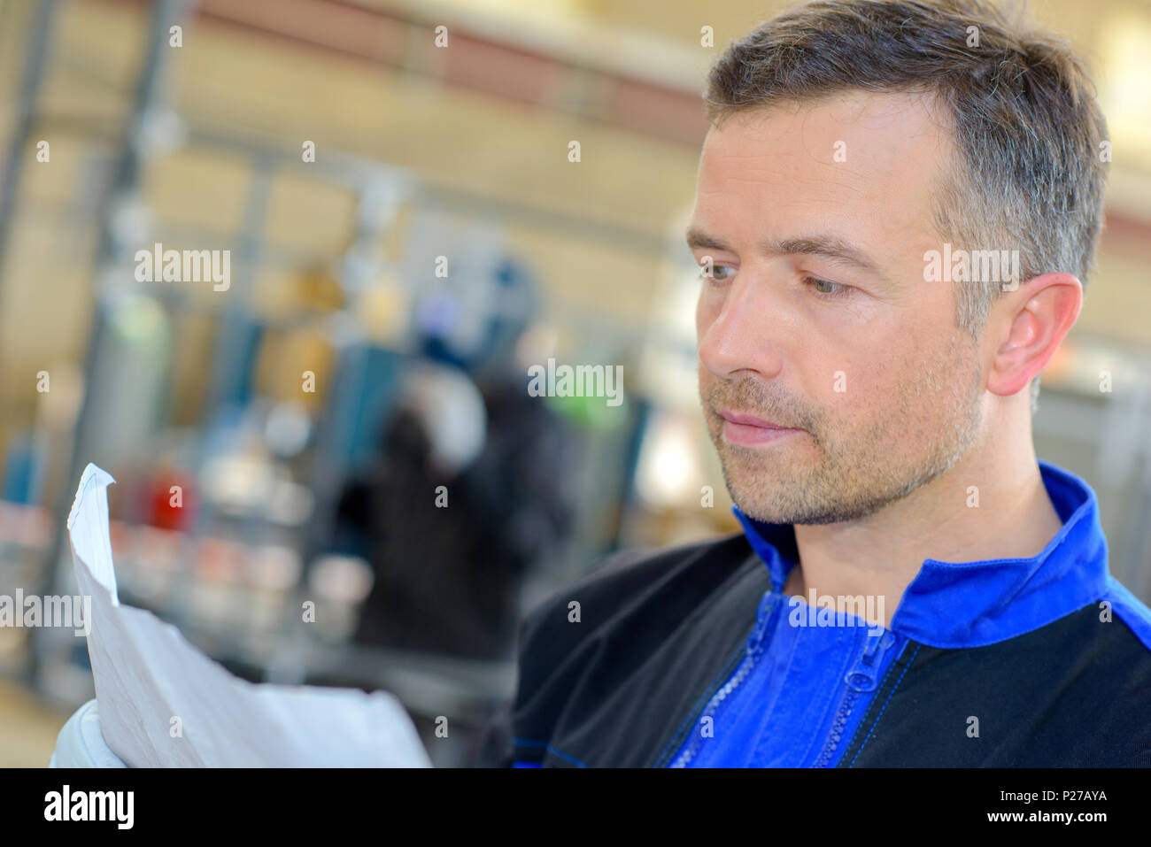 worker reading note Stock Photo - Alamy