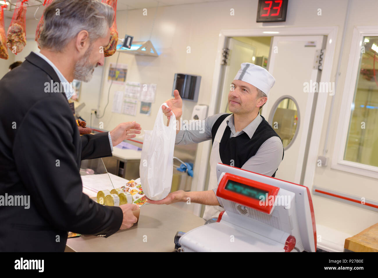 handling over the product Stock Photo - Alamy