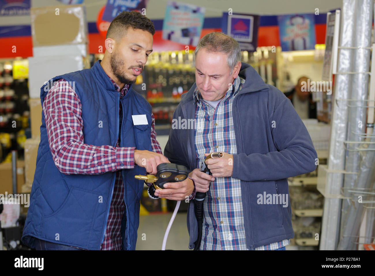 male customer in a hardware store with seller Stock Photo - Alamy