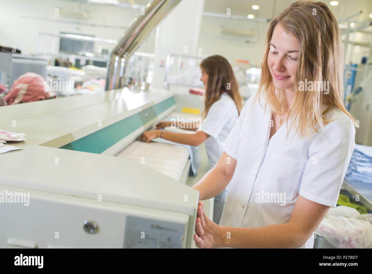 Women working in industrial laundry Stock Photo - Alamy