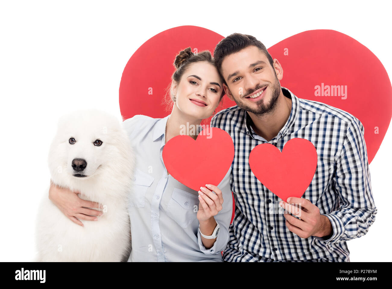 happy couple with samoyed dog and paper hearts isolated on white ...