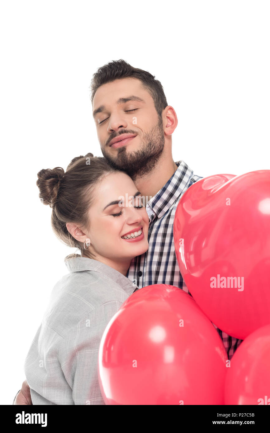 couple hugging and holding heart shaped balloons isolated on white ...