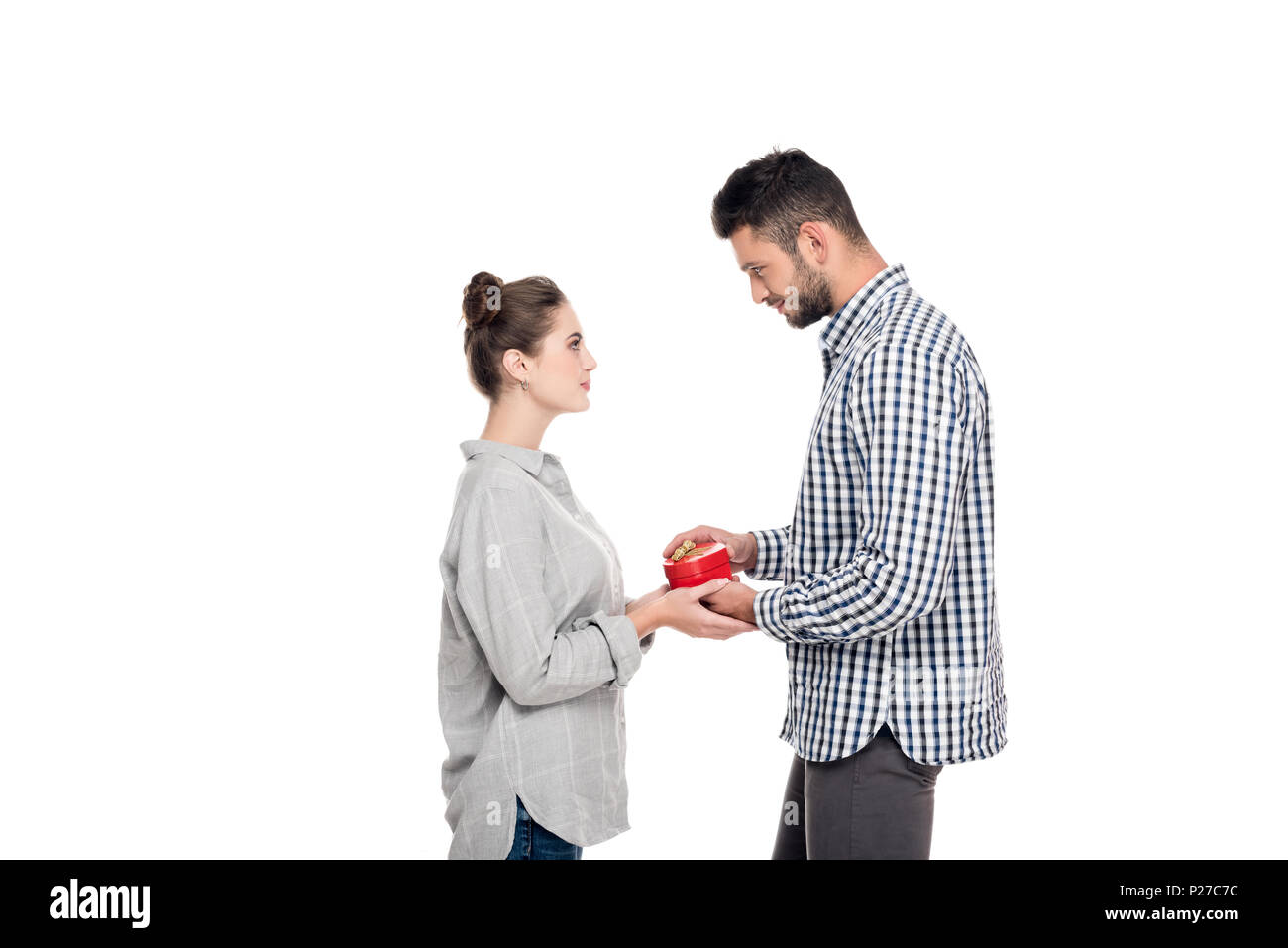 side view of girlfriend giving boyfriend present box isolated on white ...