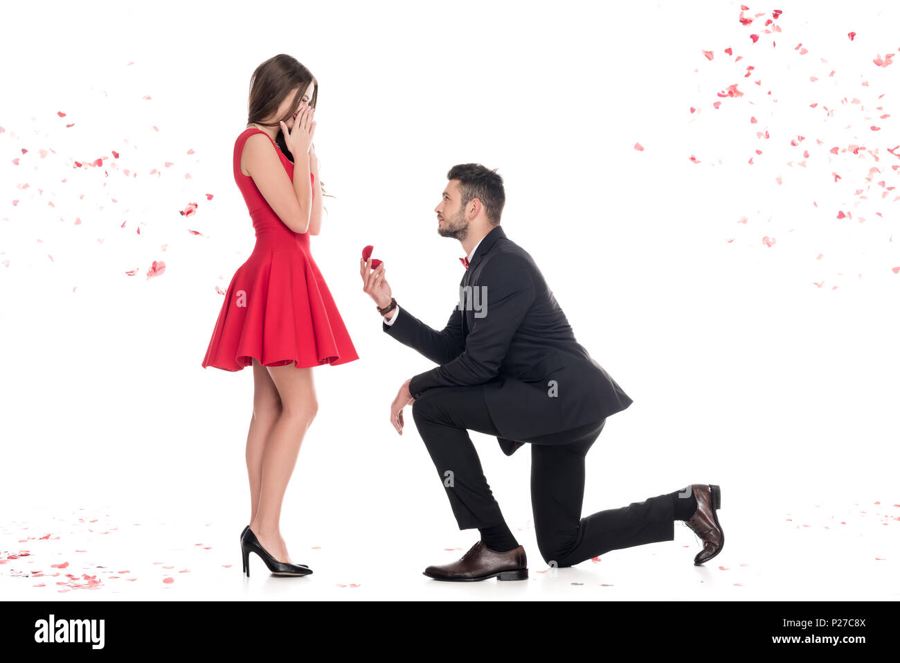 side view of boyfriend proposing girlfriend and standing on knee ...