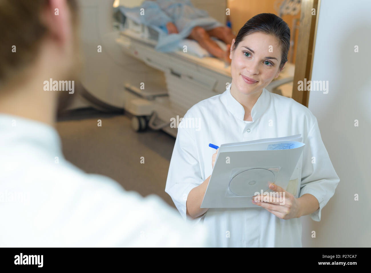 Nurse completing paperwork Stock Photo - Alamy