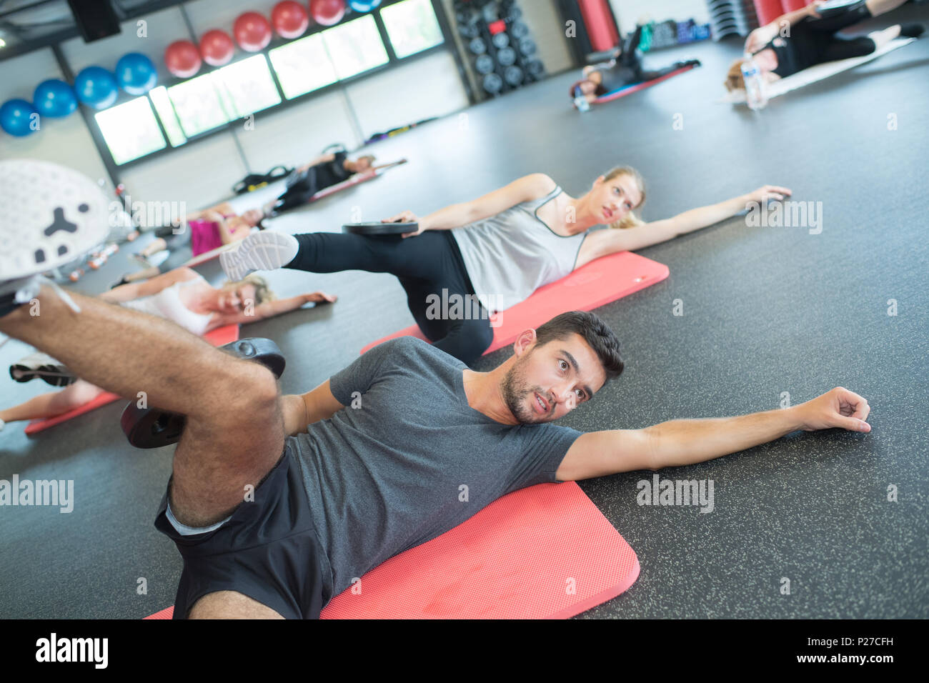 group of people on floor doing leg exercises Stock Photo - Alamy