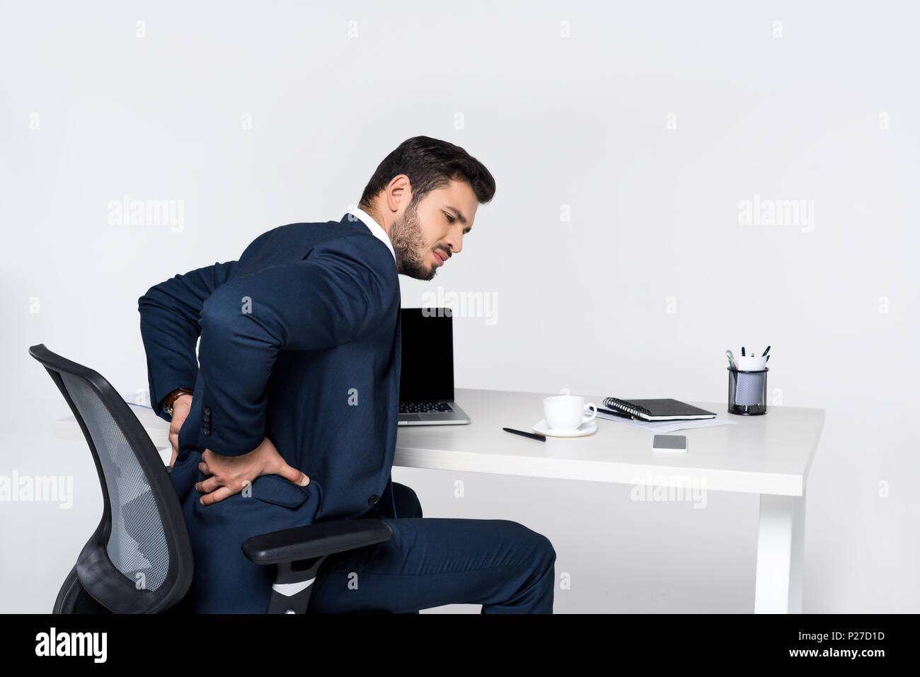 Businessman suffering from back pain hi-res stock photography and ...