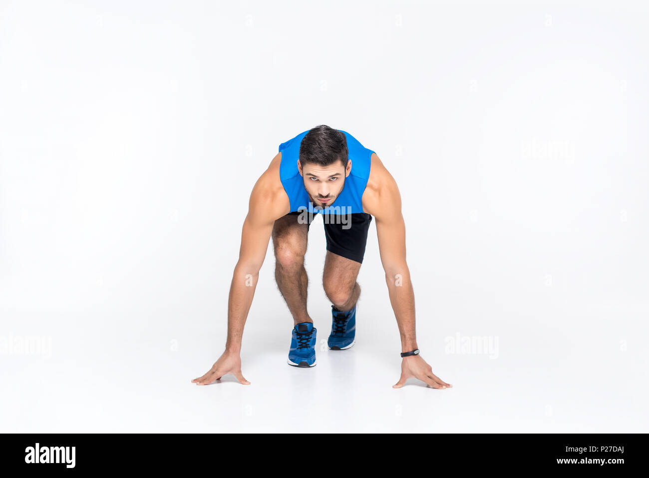 handsome young sprinter in start position isolated on white Stock Photo ...