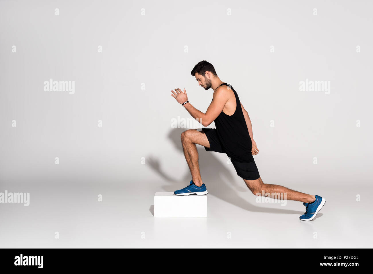 side view of athletic man doing step aerobics on block Stock Photo - Alamy