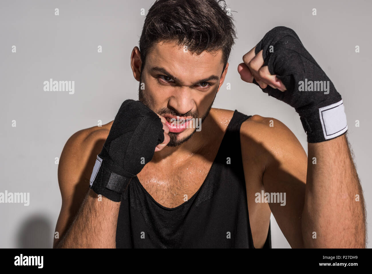 close-up portrait of exhausted fighter standing in defence position ...