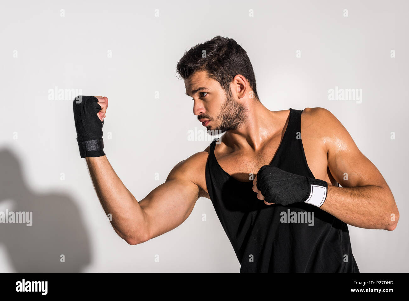 side view of young fighter making hit Stock Photo - Alamy
