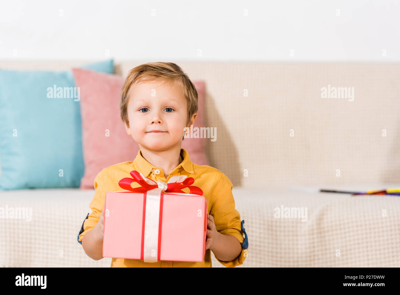 portrait of cute little boy holding wrapped present in hands Stock ...