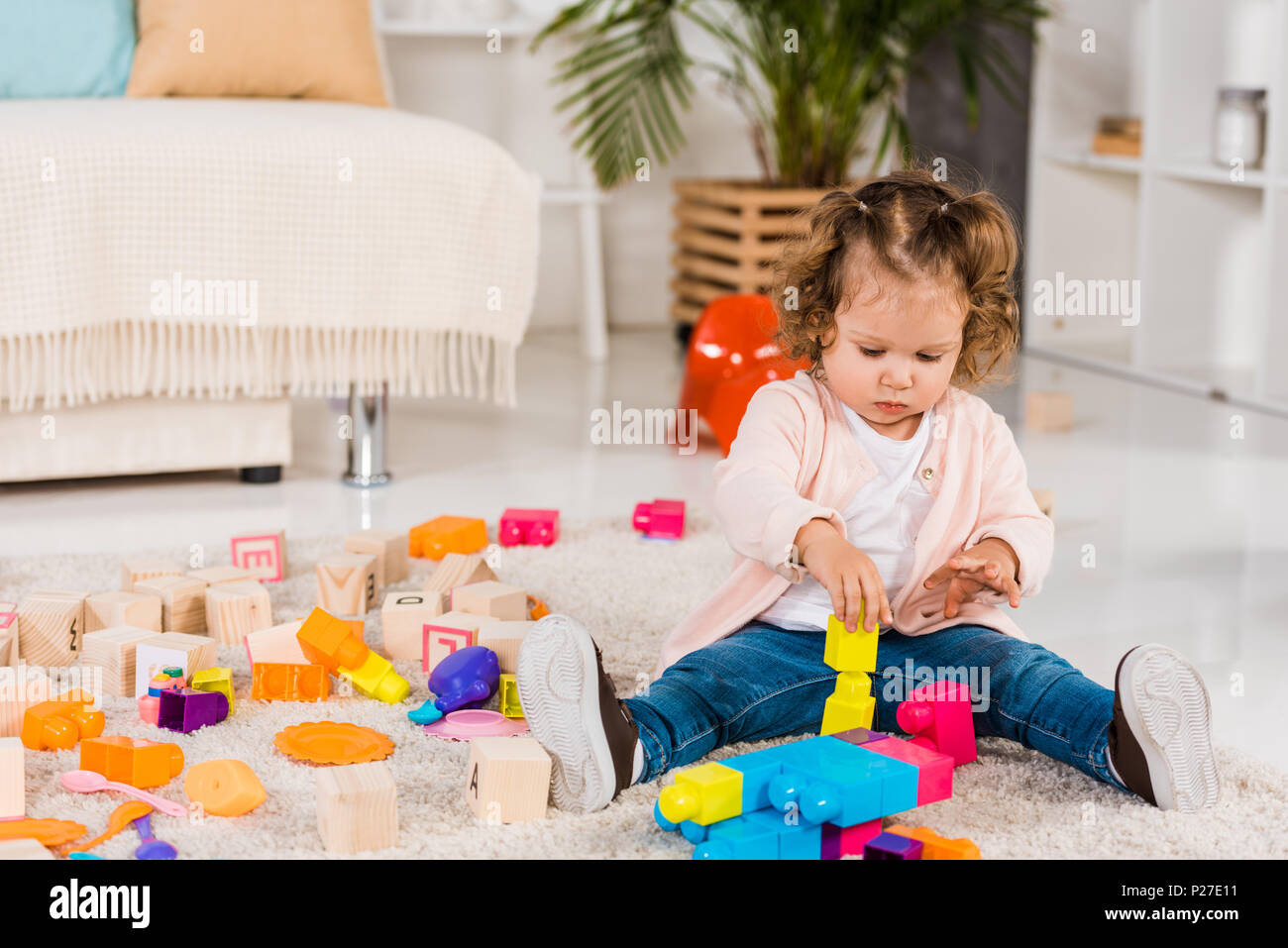 Child playing blocks on floor hi-res stock photography and images - Alamy