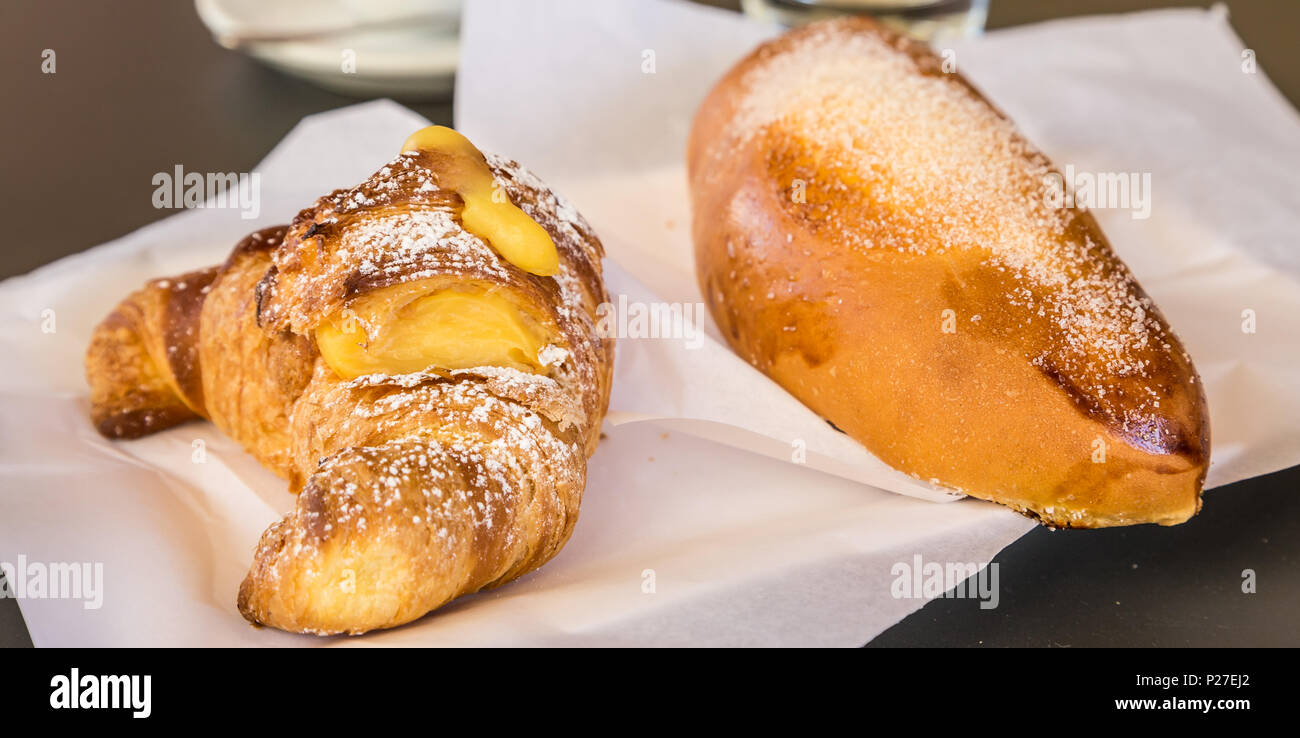 Syracuse in Sicily, Italy. Traditional fresh brioches with cream served ...
