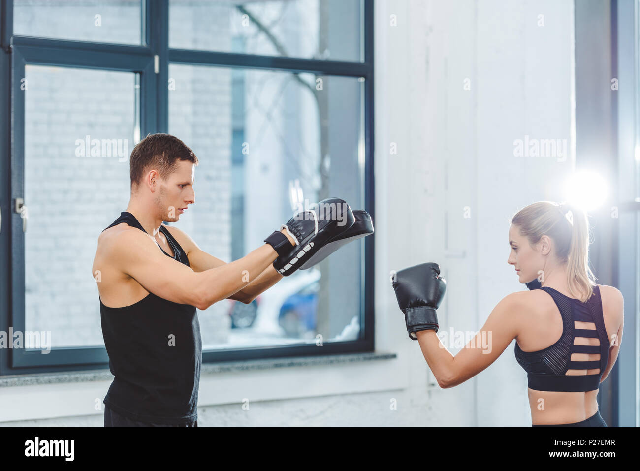 side view of young sporty couple boxing in gym Stock Photo - Alamy