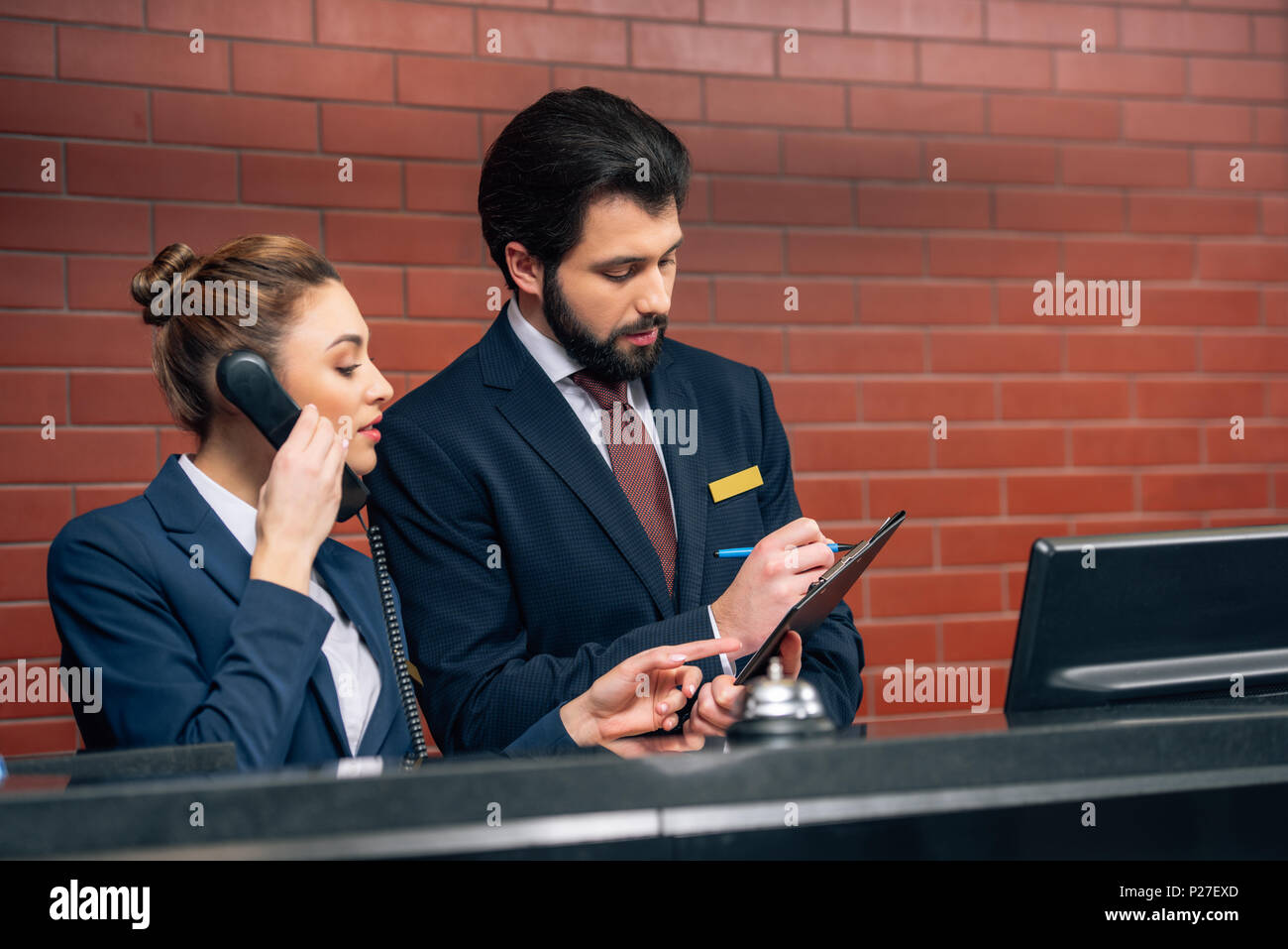Female male receptionists working hi-res stock photography and images - Alamy