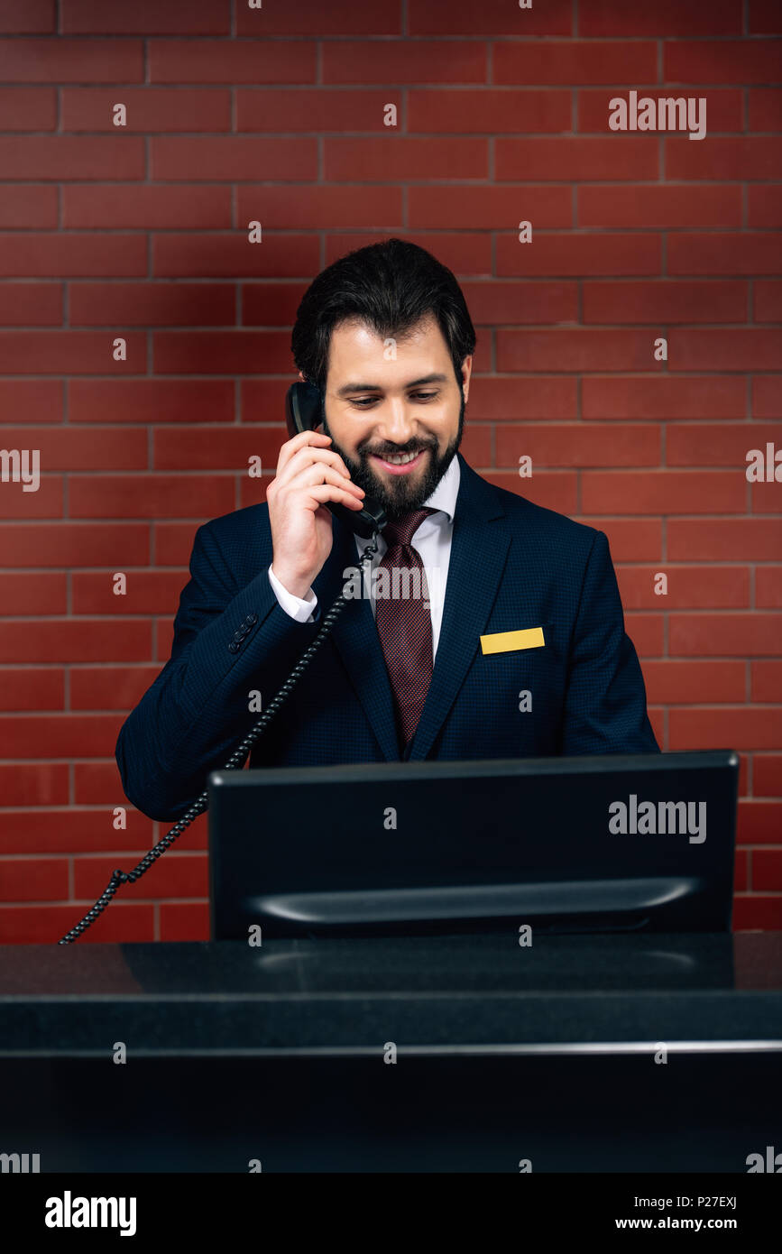 hotel receptionist taking phone call at workplace Stock Photo - Alamy
