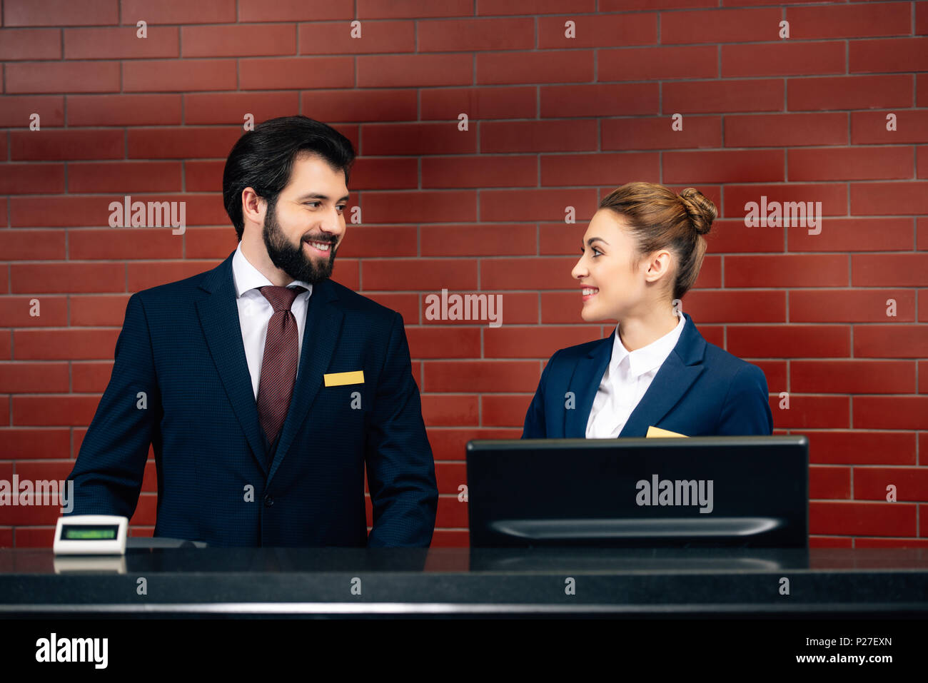 Smiling receptionists working reception hi-res stock photography and ...