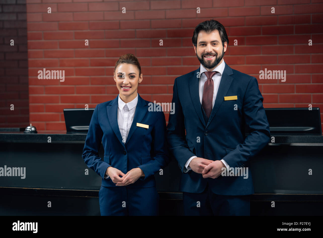Hotel staff standing together smiling hi-res stock photography and ...