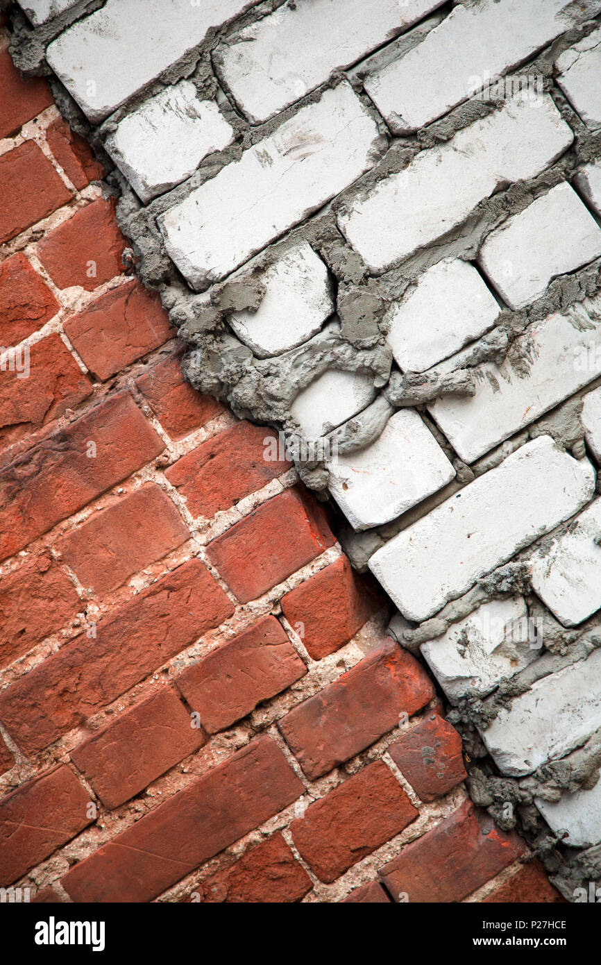 Brick old wall divided into two parts white and red , texture grunge ...